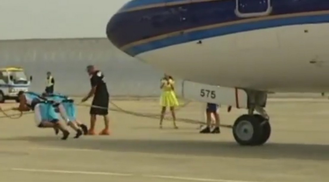 Strongmen Pull Boeing Airplane in China| Muscle & Fitness